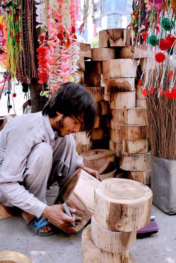 A customer selecting decorative leg ring for sacrificial animals ahead ...