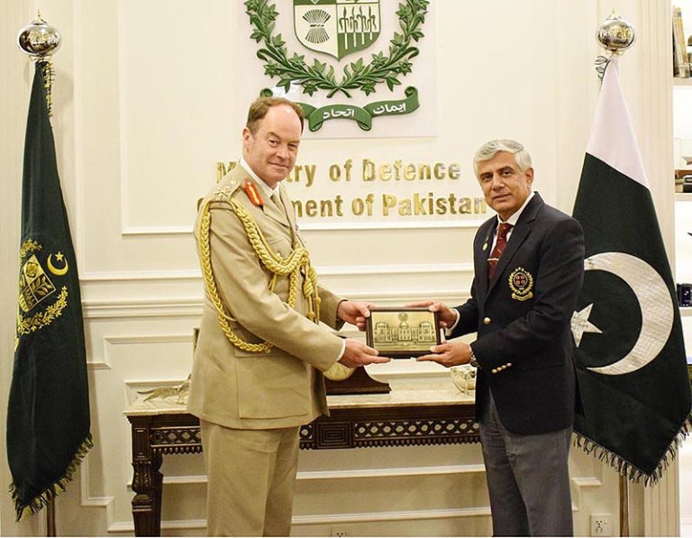 Secretary Defence, Lt Gen (Retd) Hamood Uz Zaman Khan presenting a gift ...