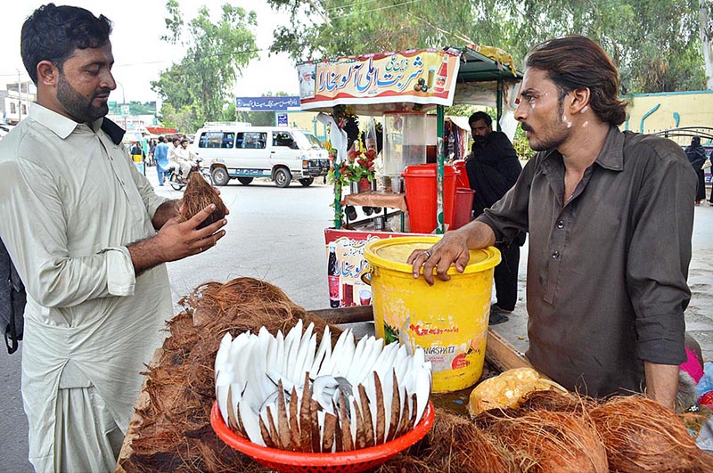 A vendor selling coconut at Kalma Chowk to earn for livelihood