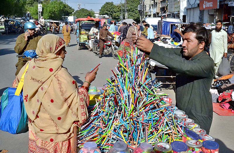 A vendor displaying the stationary item (Colorful pencils) to attract ...