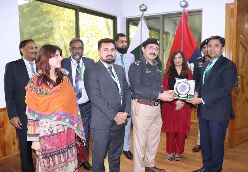 Commissioner Abbottabad, Zaheer ul Islam presenting a shield to Ms ...