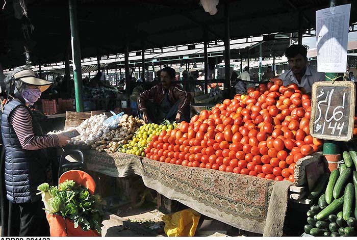 People busy in purchasing vegetables from stalls at Weekly Bazaar in ...