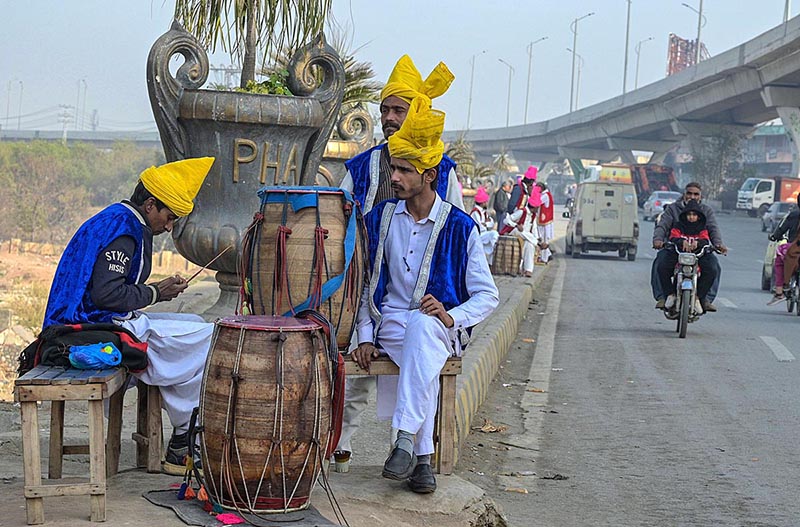 Traditional folk artists at roadside setup waiting to be hired for ...