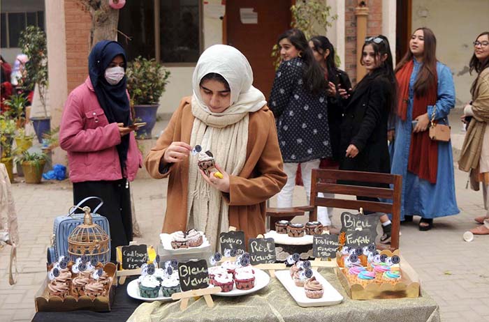Students enjoying different saltish food items from a stall during ...