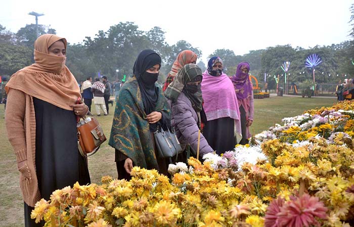 Visitor taking a keen interest in flowers during the annual Gul Dawoodi ...