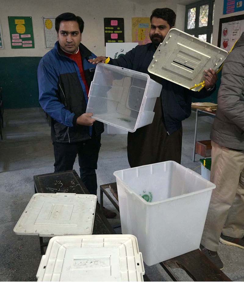 Polling officials showing the empty ballot boxes before start the ...