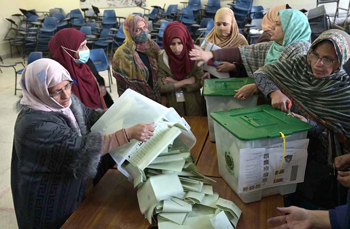 Polling official opens ballot box to count votes at a polling station ...
