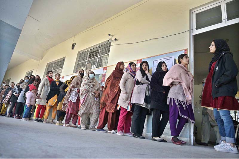 A large number of women standing in queue to cast their vote in the ...