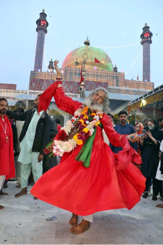 Devotees performing dhamal at the shrine of Hazrat Lal Shahbaz Qalandar ...