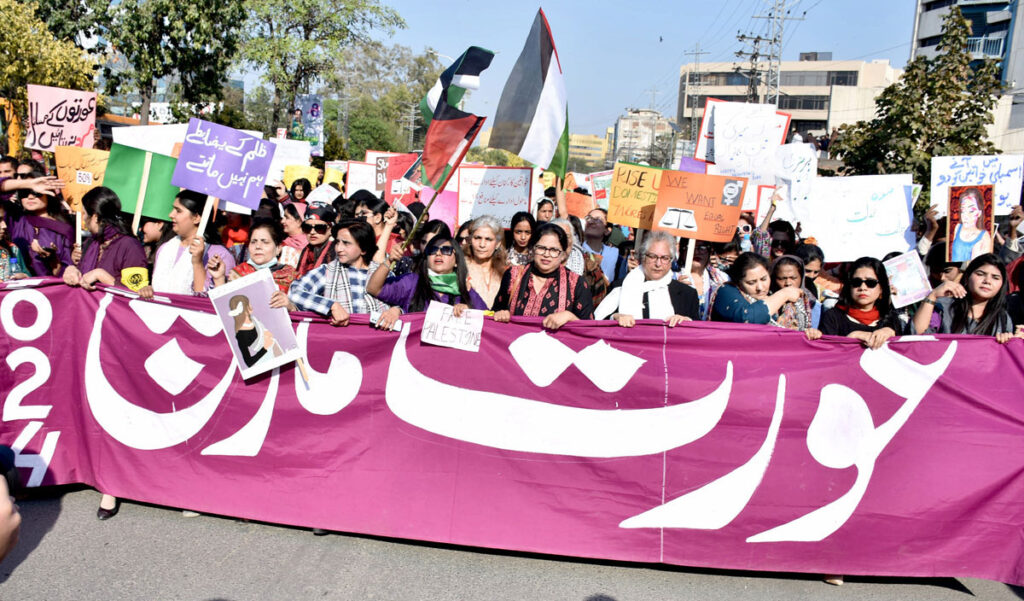 Participants displaying placards as a large women from all walks of ...