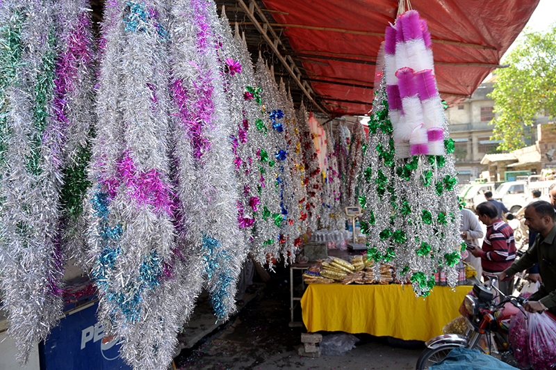 A vendor displaying garlands to attract customers at at Bani Chowk