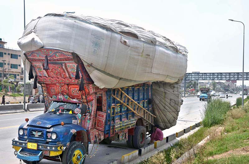 A view of truck heavily loading with chaff (husk from wheat) at IJP Road.