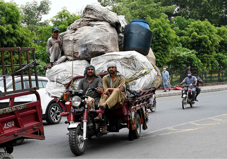 A person riding an overloaded tricycle rickshaw which may cause any ...