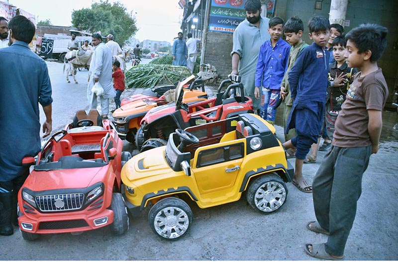 Vendor displaying used toy cars outside his shop at Garhi Shahu.
