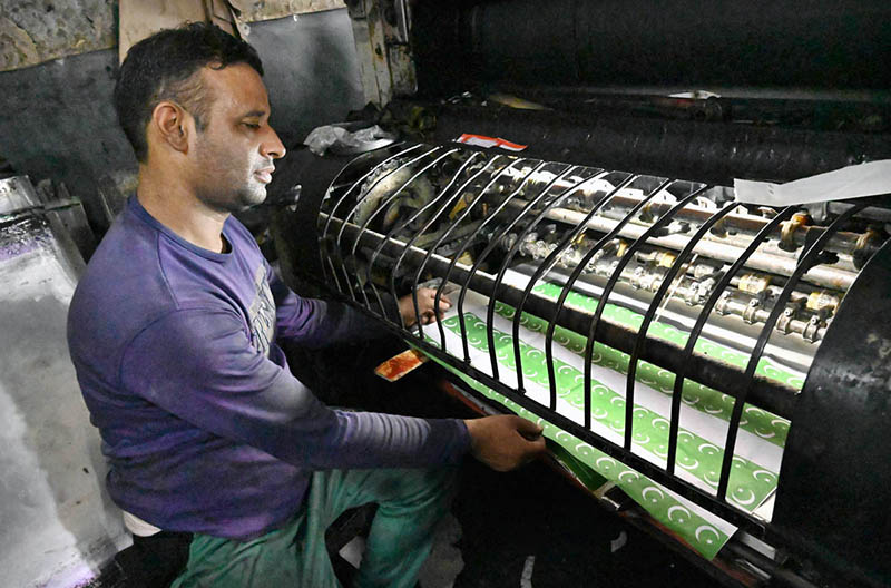 Paper flags of Pakistan are being printed at the printing press in ...