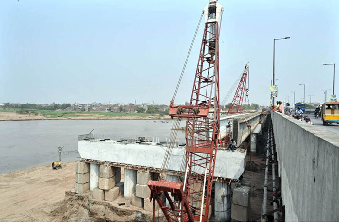 A view of construction work of Ravi Bridge is in progress.