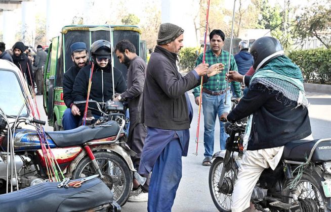Ahead of Basant, people install safety rods on motorcycles along Multan ...